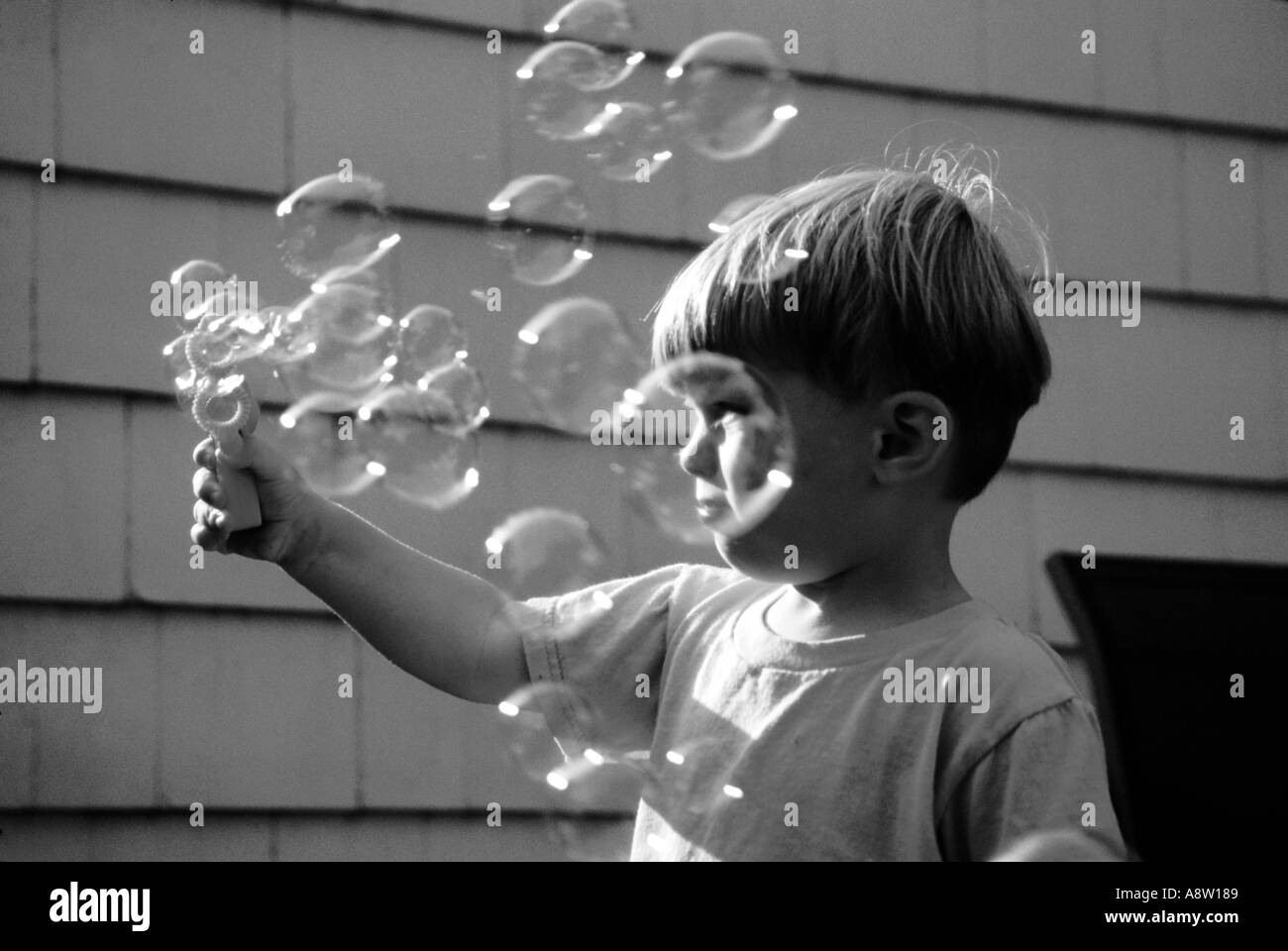 small boy playing with bubbles child with bubbles Stock Photo - Alamy