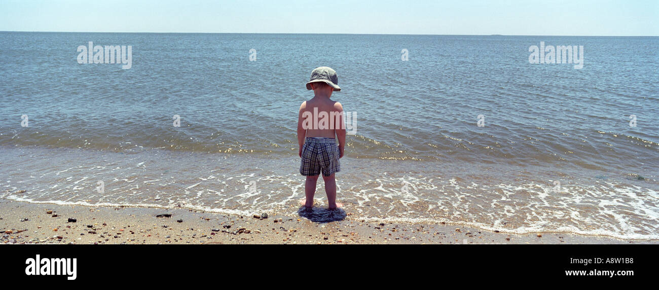 Small boy looking at the quiet sea hi-res stock photography and images ...