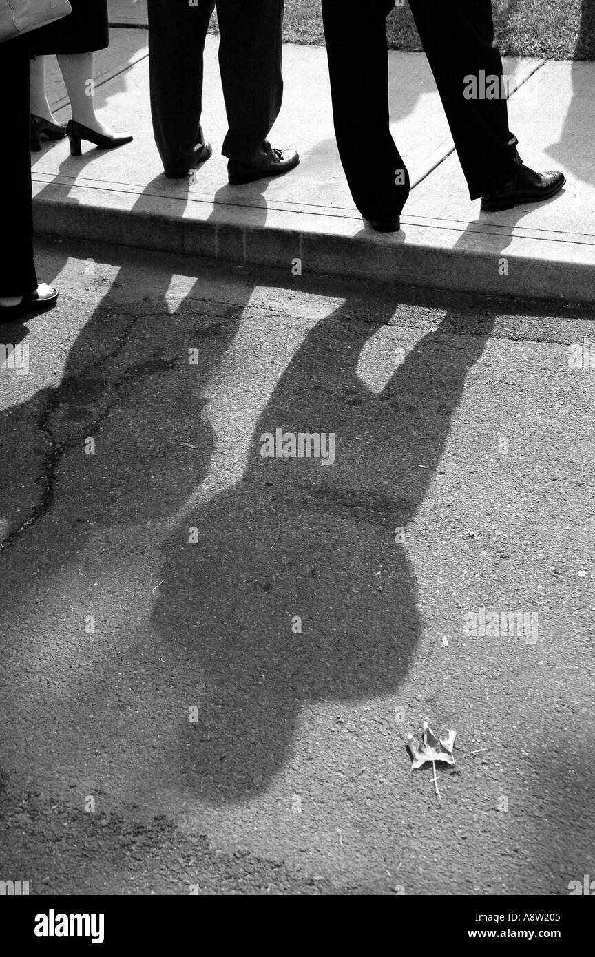 People at an event with shadows and feet concept Stock Photo - Alamy