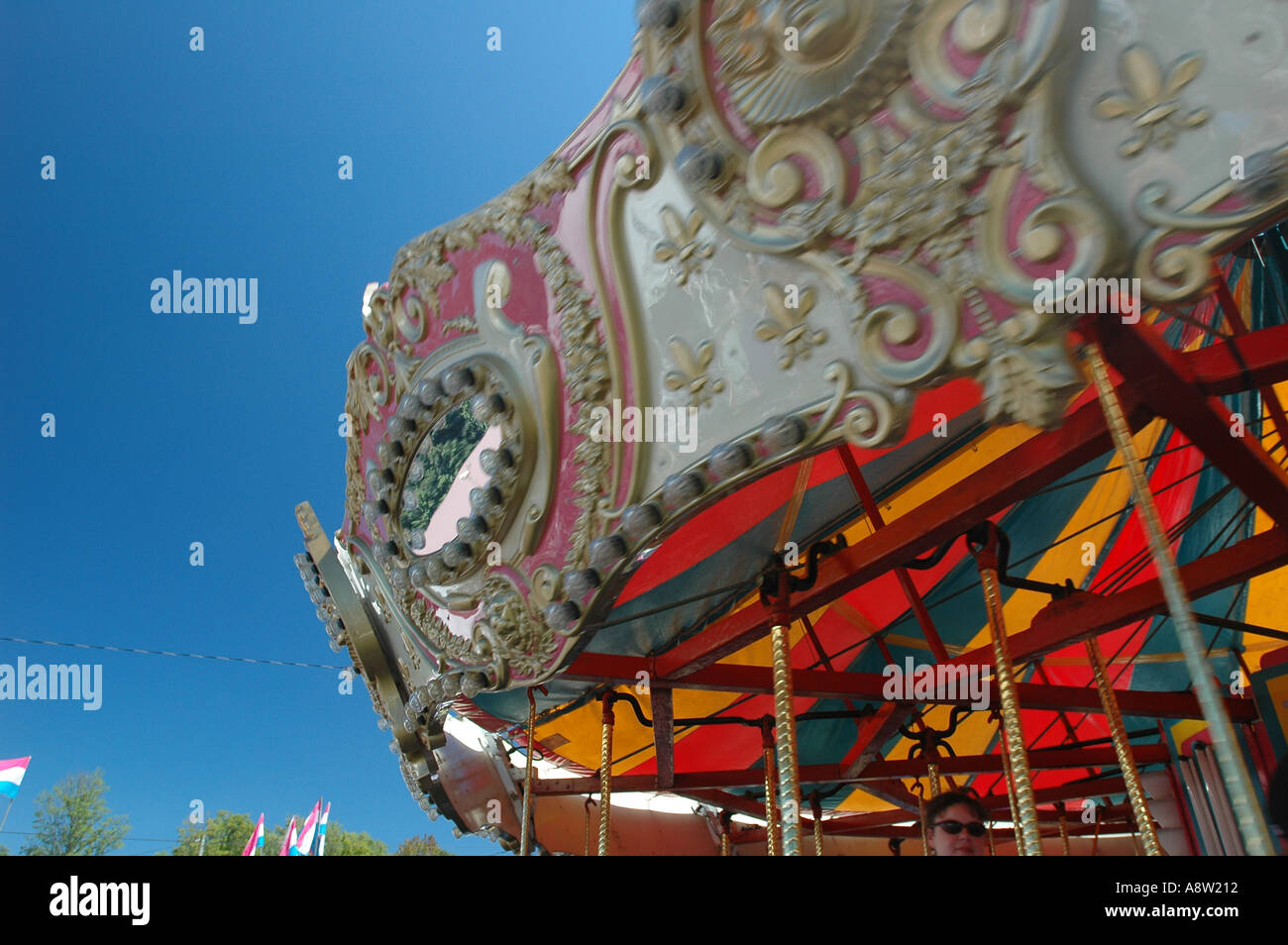 Merry go round ride with blue sky at a carnival Stock Photo - Alamy
