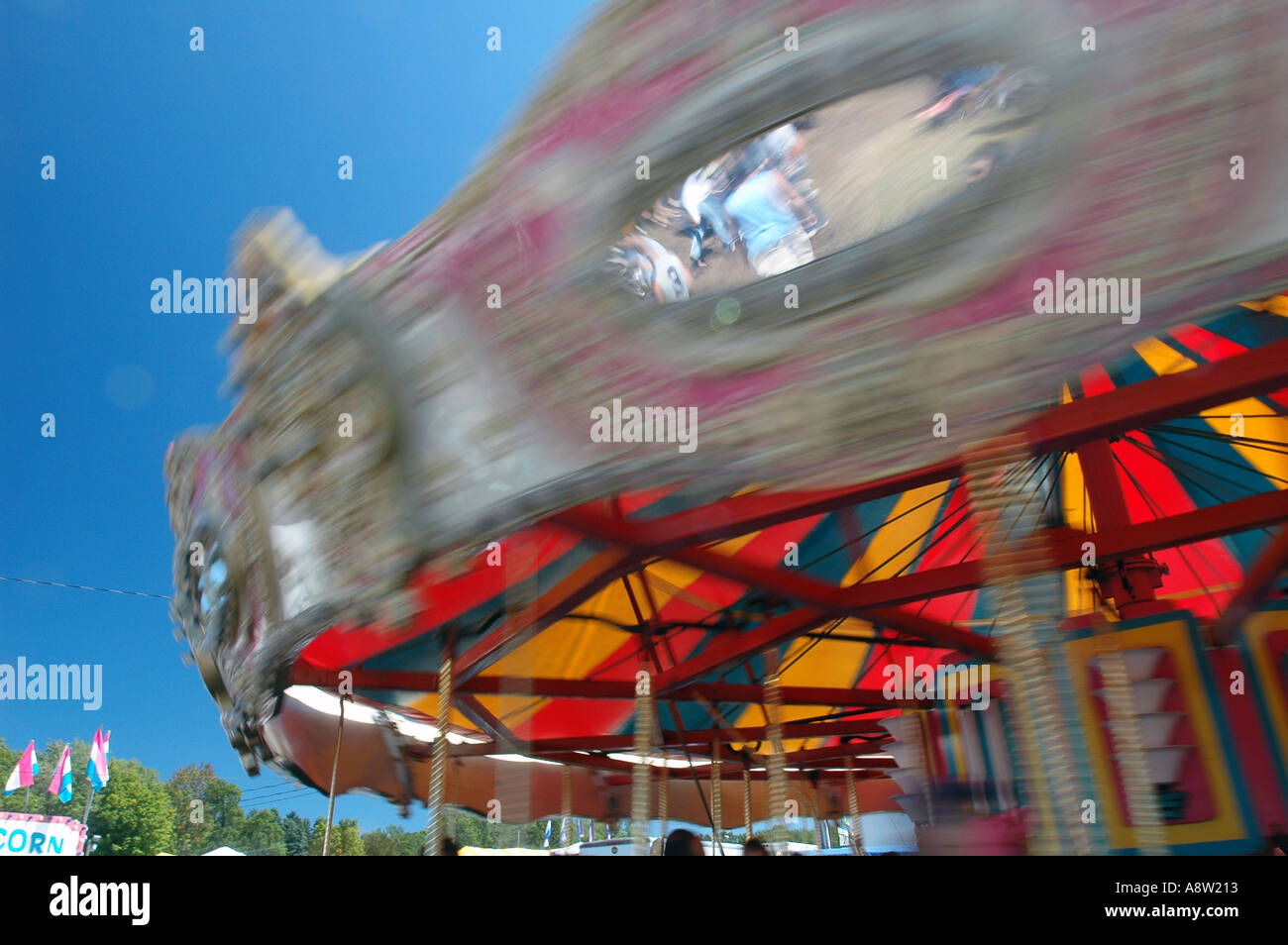 Merry go round ride with blue sky at a carnival Stock Photo - Alamy