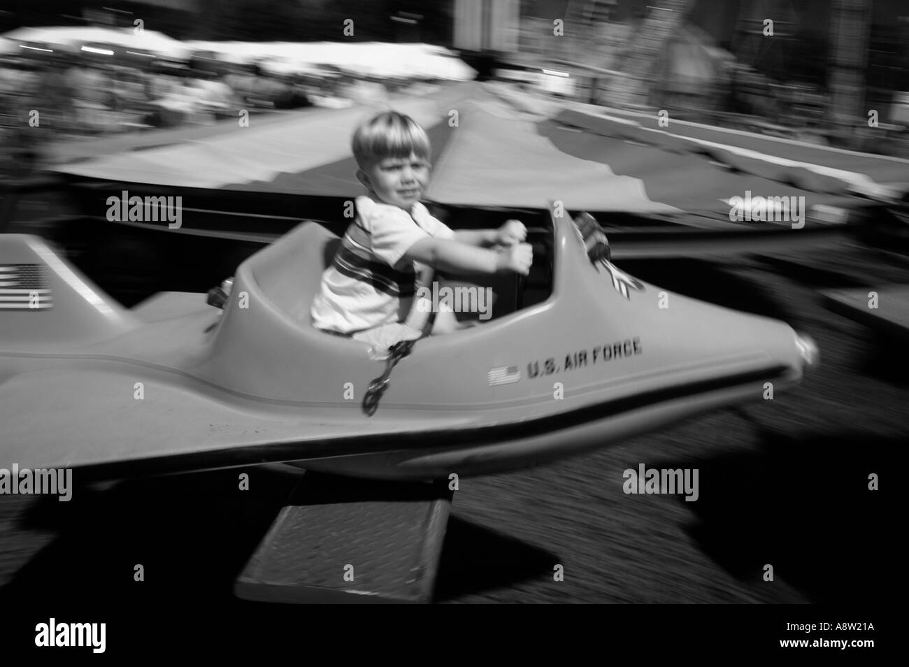 Litte boy riding a rocket ship ride at a carnival Stock Photo - Alamy