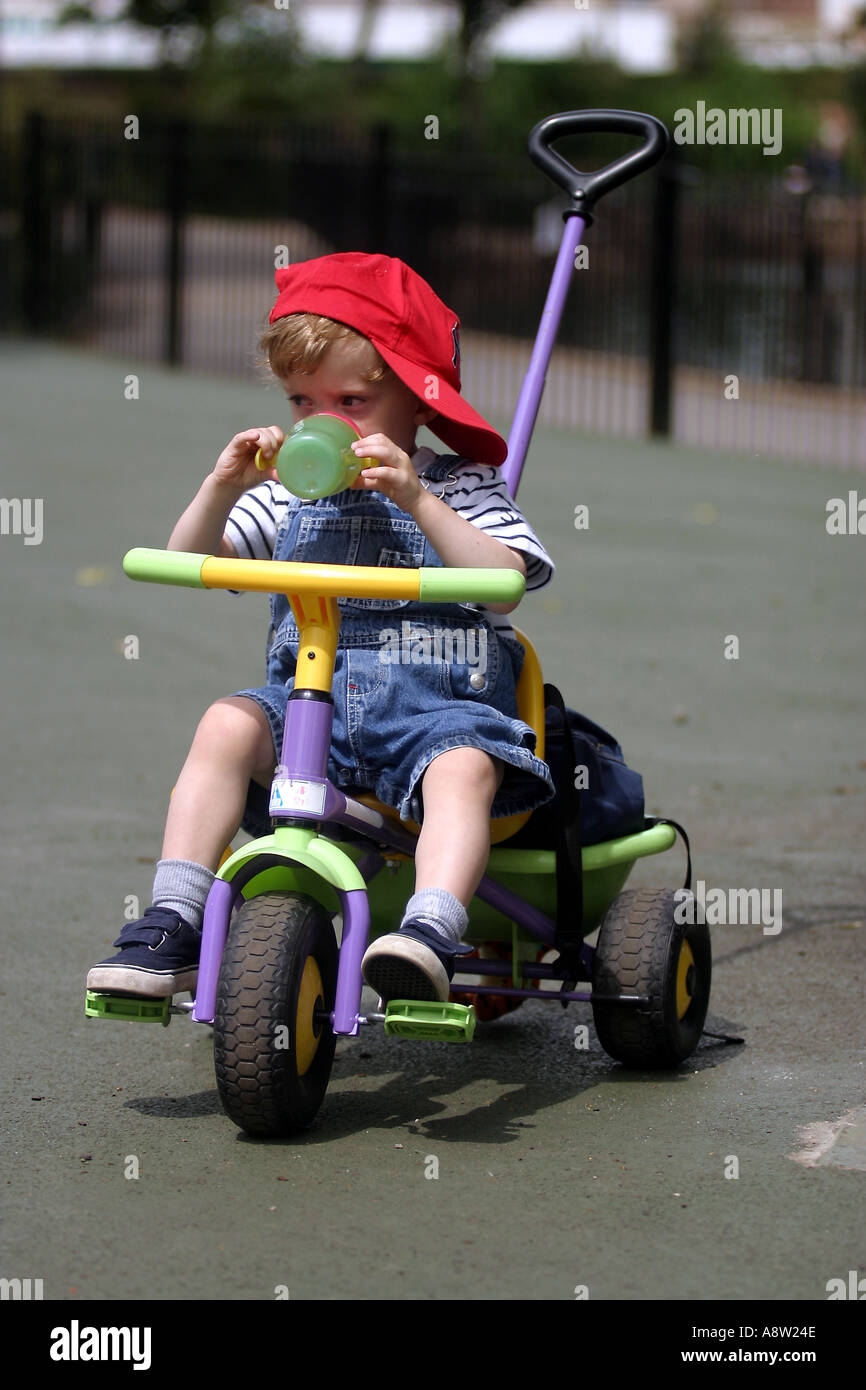 boy aged three in Arnot Park on his tricycle Stock Photo - Alamy
