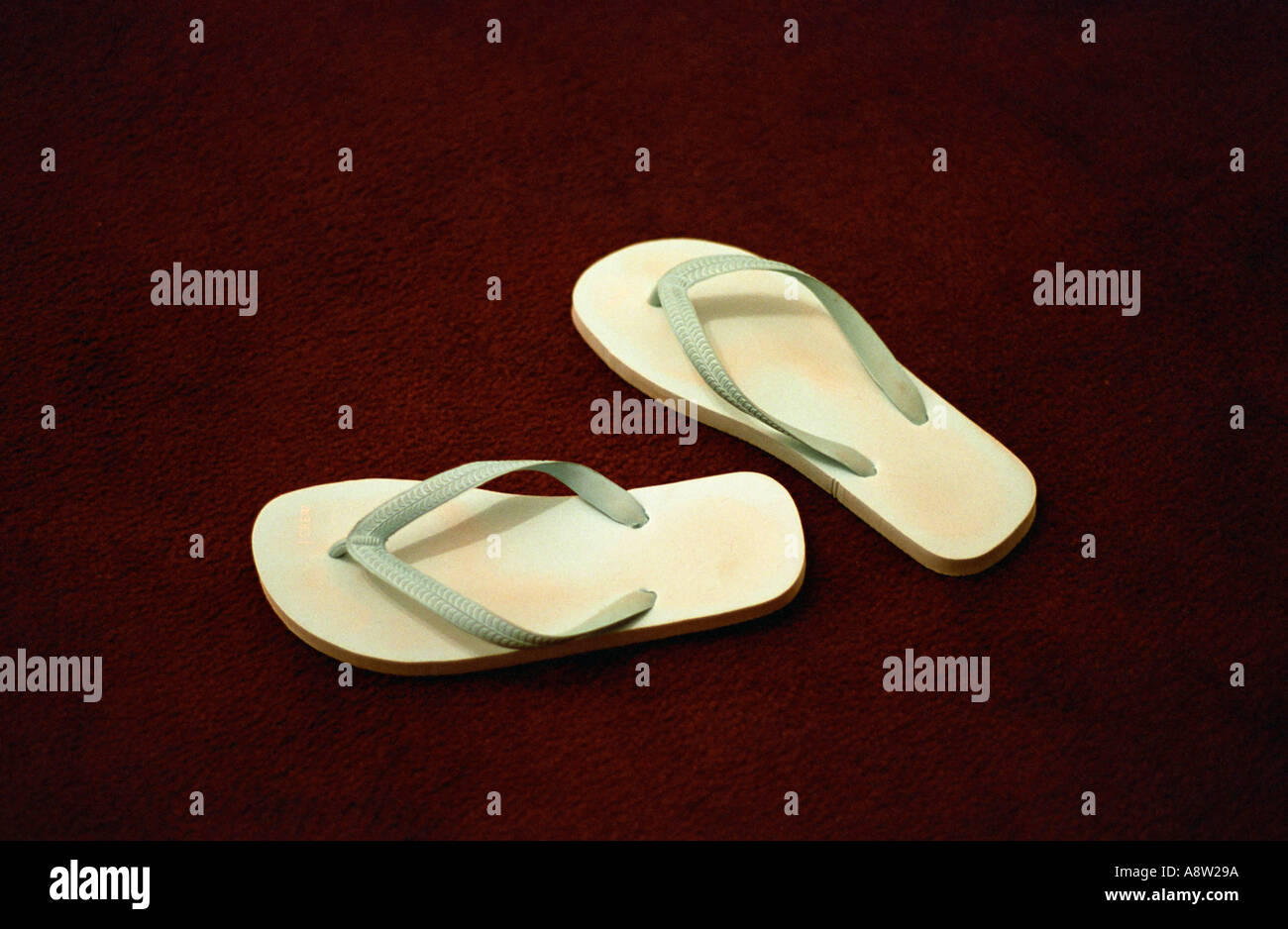 Pair of flip flops on carpet Stock Photo - Alamy