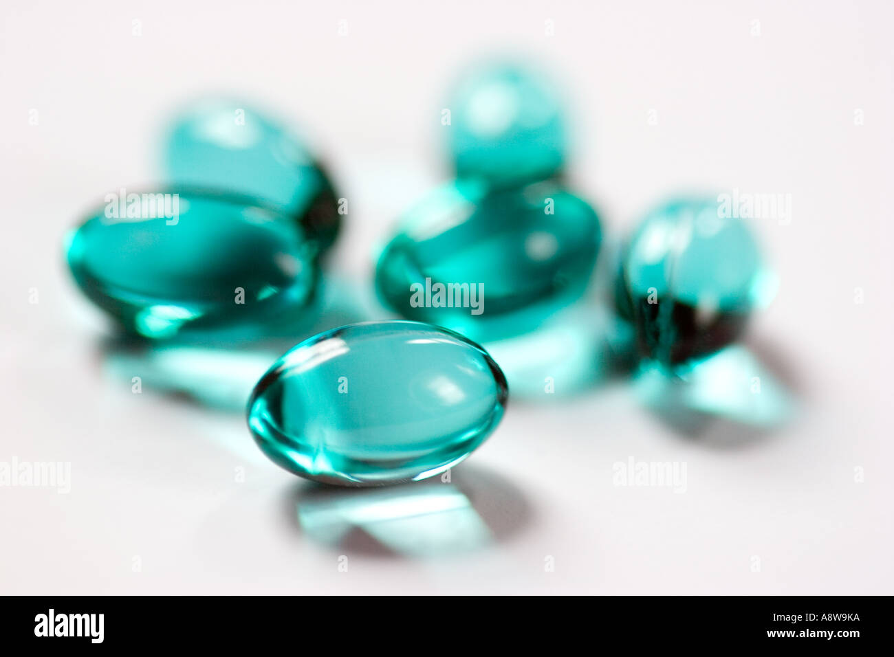 Ibuprofen capsules against a white background Stock Photo - Alamy