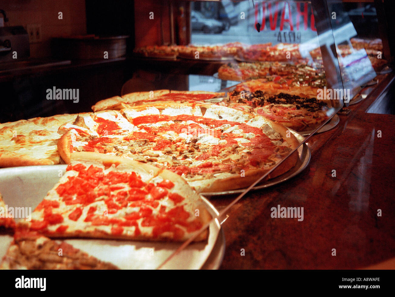 Pizza pies on display in pizzeria Stock Photo - Alamy
