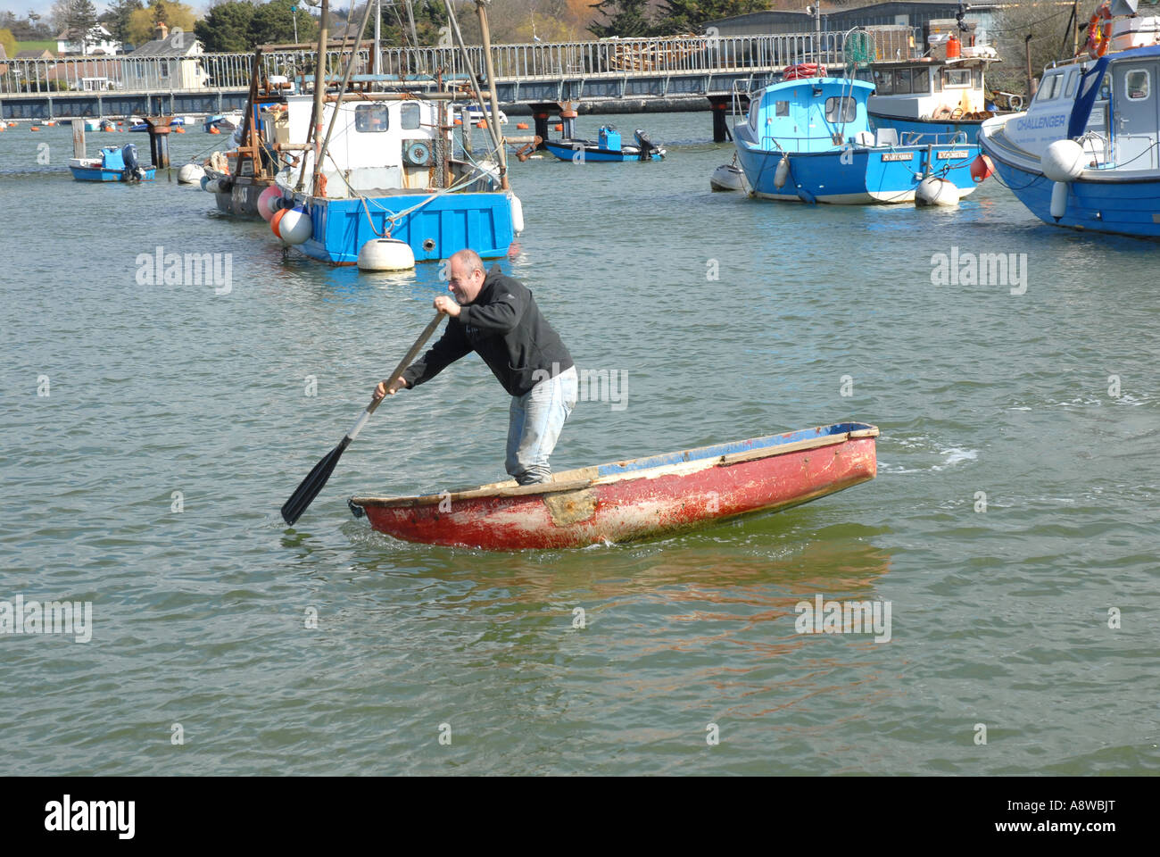 trawlerman sculling his dory ashore Stock Photo - Alamy