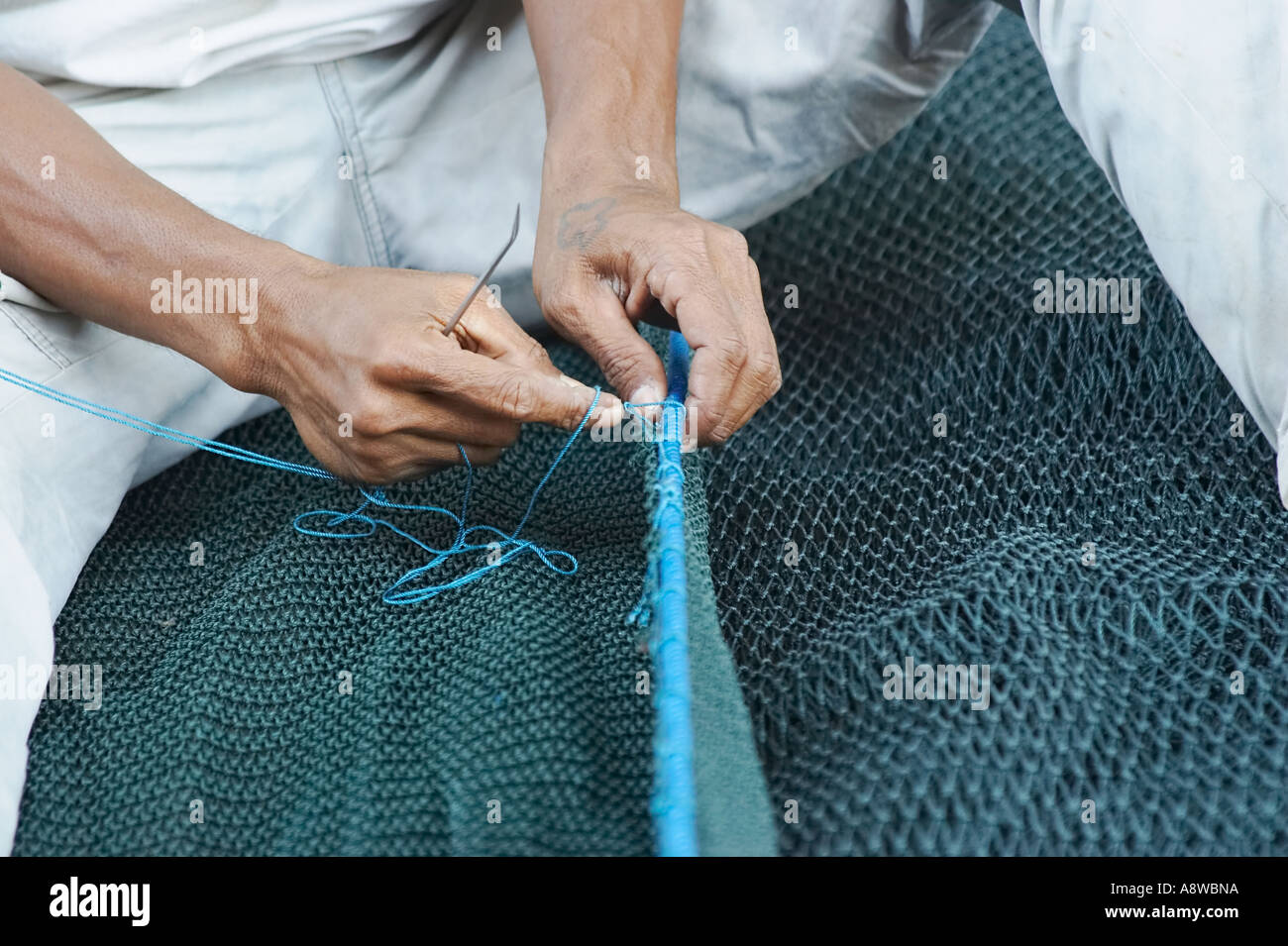 Seated man repairing net hi-res stock photography and images - Alamy