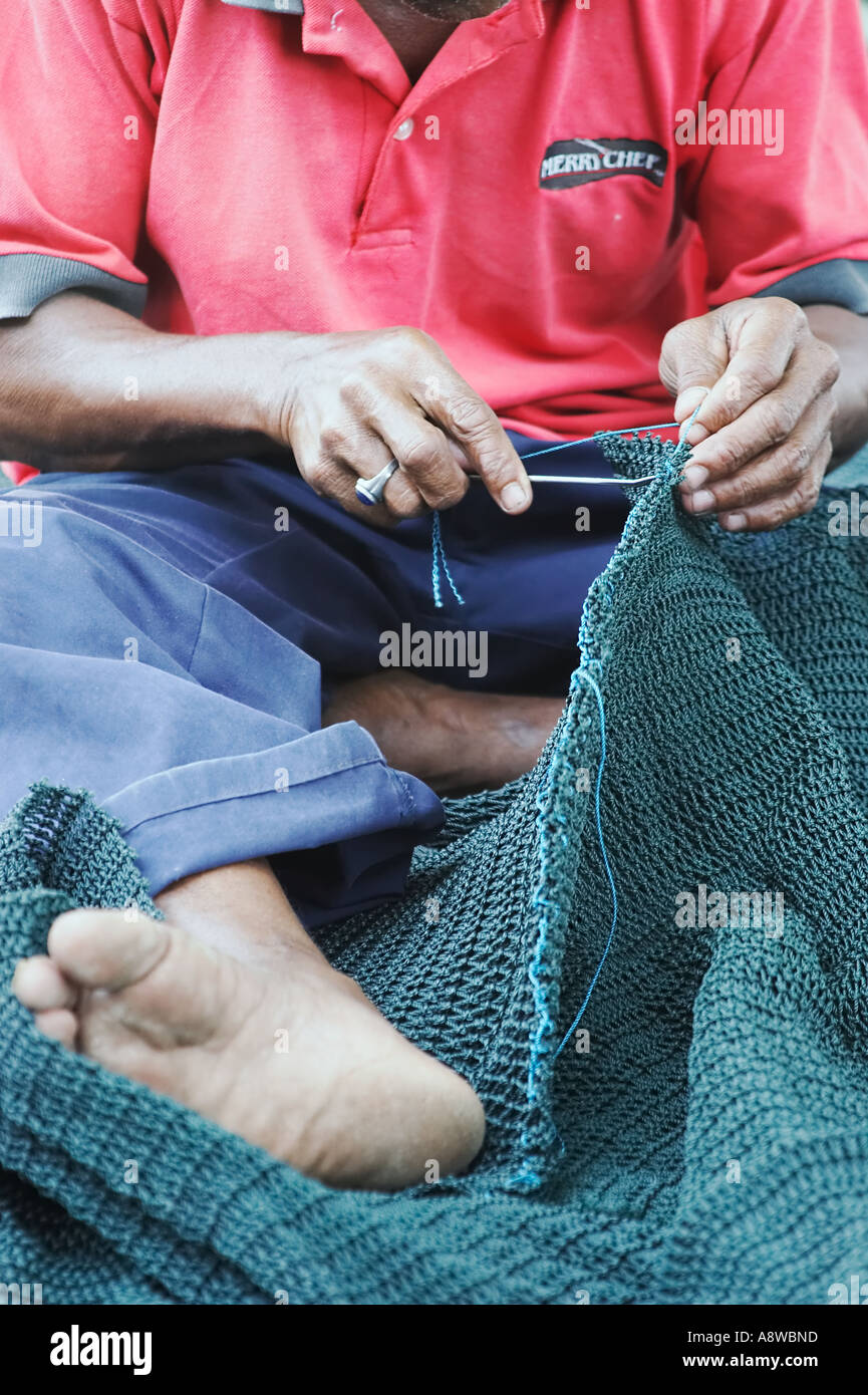 Seated man repairing net hi-res stock photography and images - Alamy