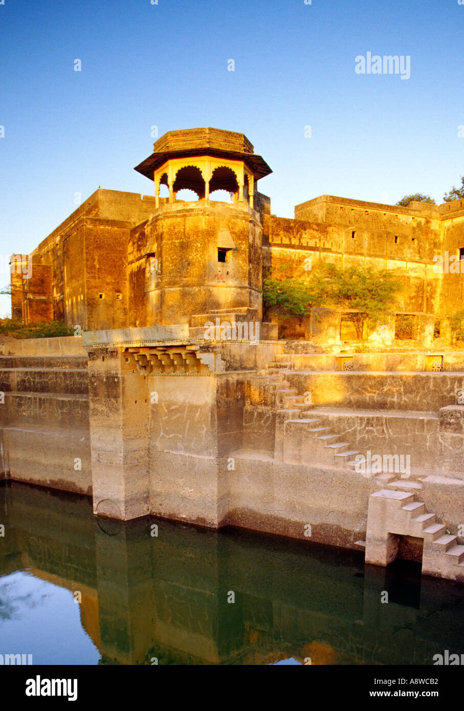 Indian Stair well mostly full with rain water with a stone fort in the ...
