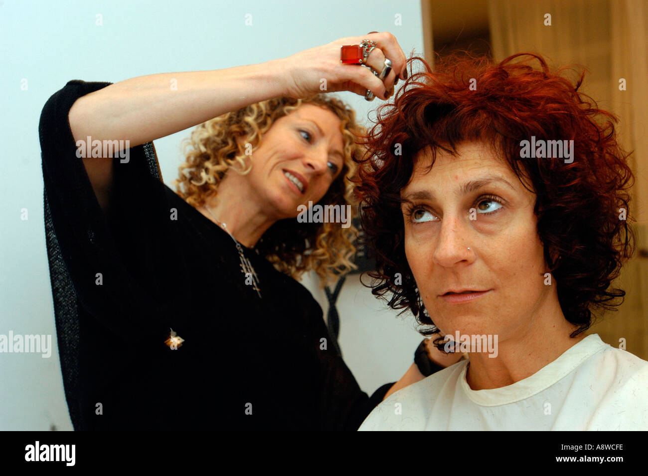 Customers at the Devachan Salon in Soho get their hair styled Stock ...