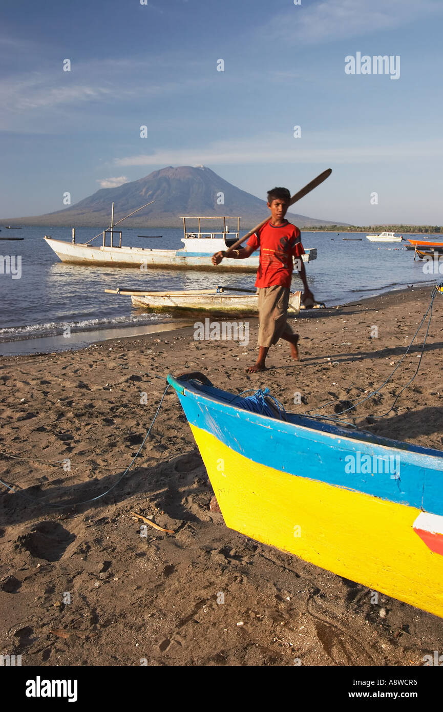 Boy Walking Along Beach Carrying Oar Stock Photo - Alamy