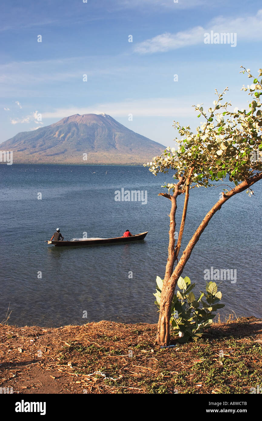 Fishing Boat In Front Of Volcano Stock Photo - Alamy