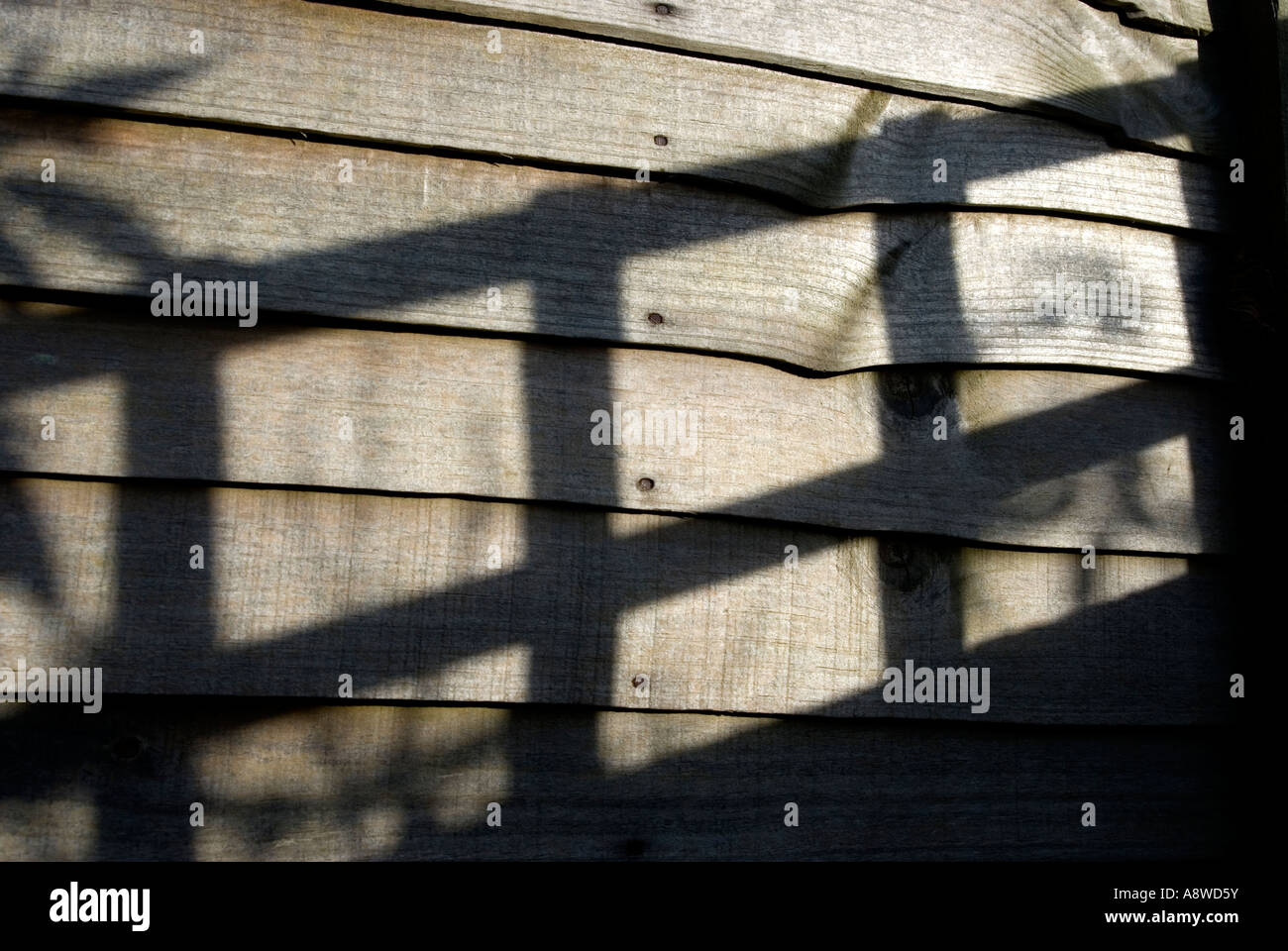 Fence shadow on wooden wall Stock Photo - Alamy