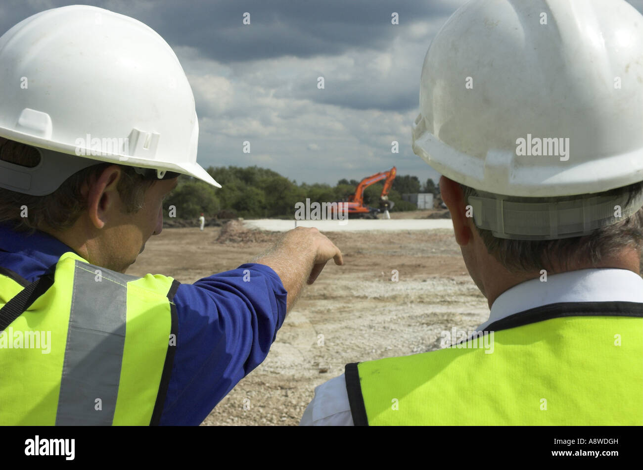 Two construction men working on site Stock Photo - Alamy