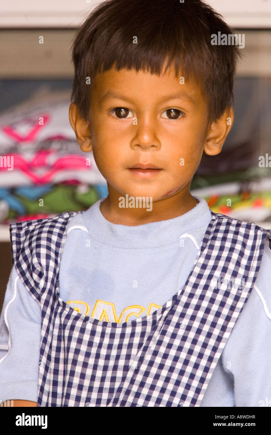 Young native Ecuadoran helping his mom in the store Stock Photo - Alamy