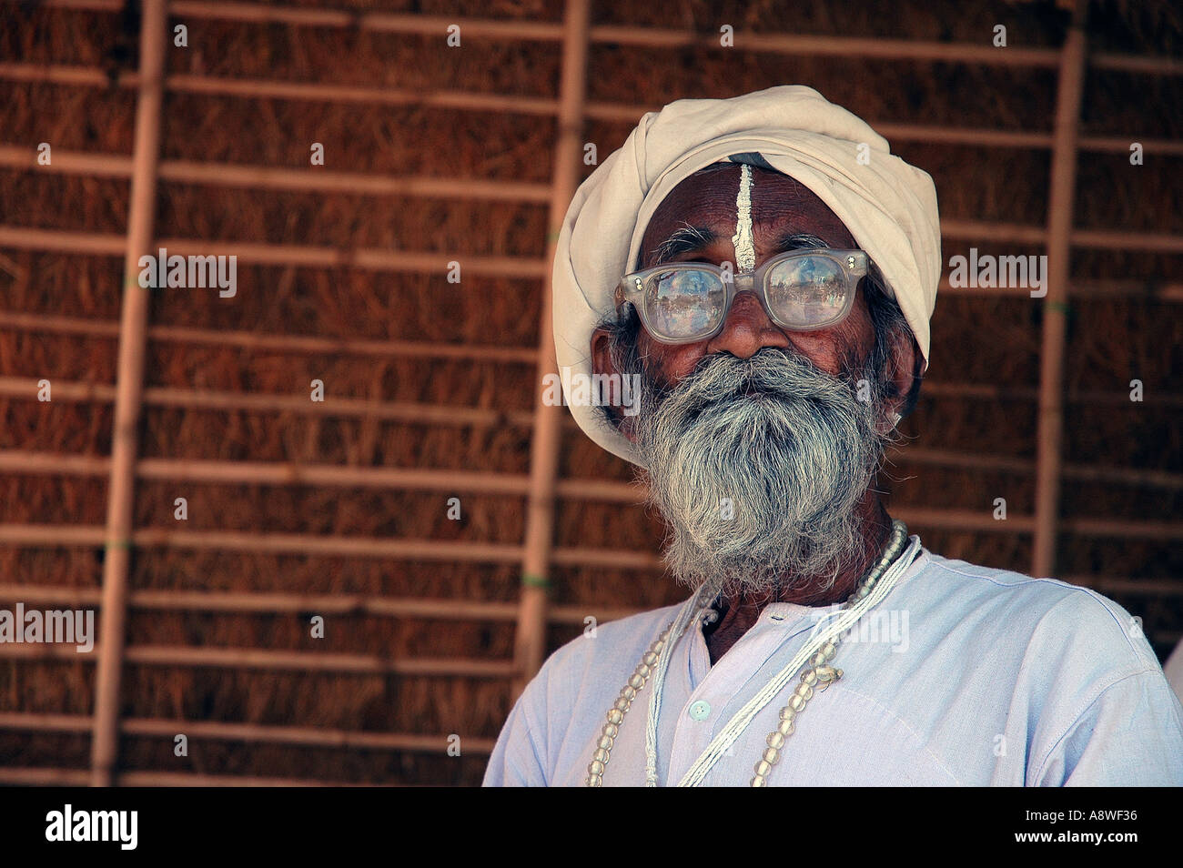 SUB90518 Old Indian priest with white beard pearl necklace tilak specs ...