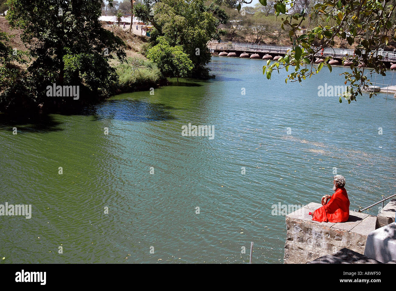 SUB90544 Indian lonely single man priest sadhu meditating on calm river ...