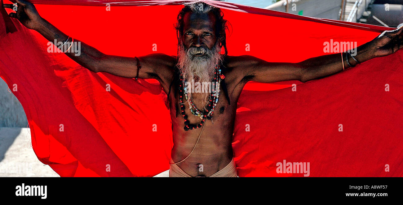Indian holy man priest sadhu dancing rejoicing with red dress dhoti ...