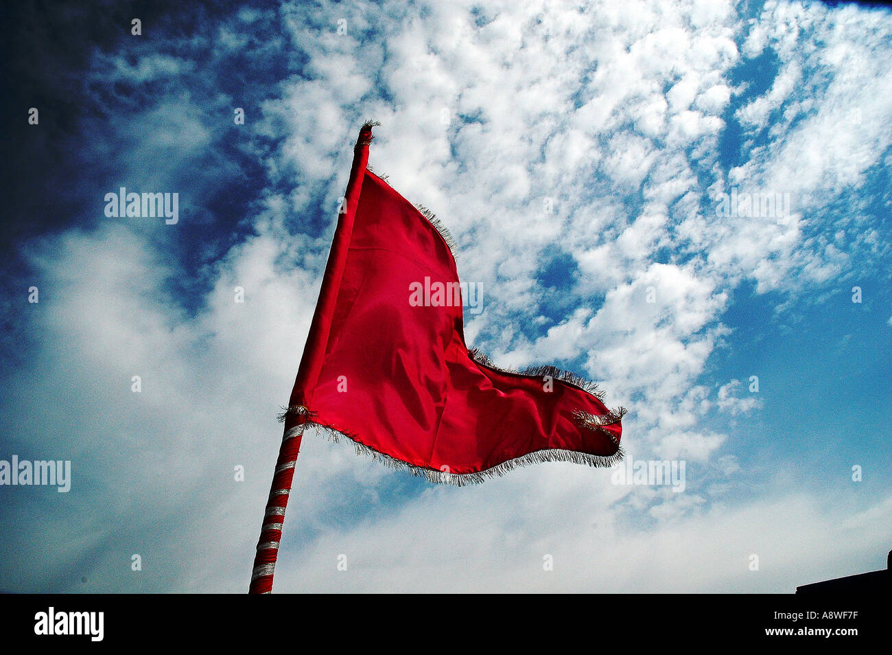 SUB90582 Indian red religious flag fluttering against blue sky white ...