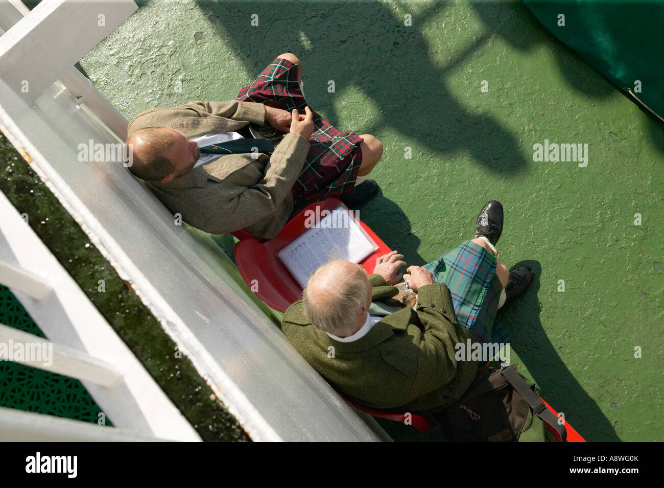 Two bald men in Tartan Kilts sitting on ferry to Mull photographed from ...