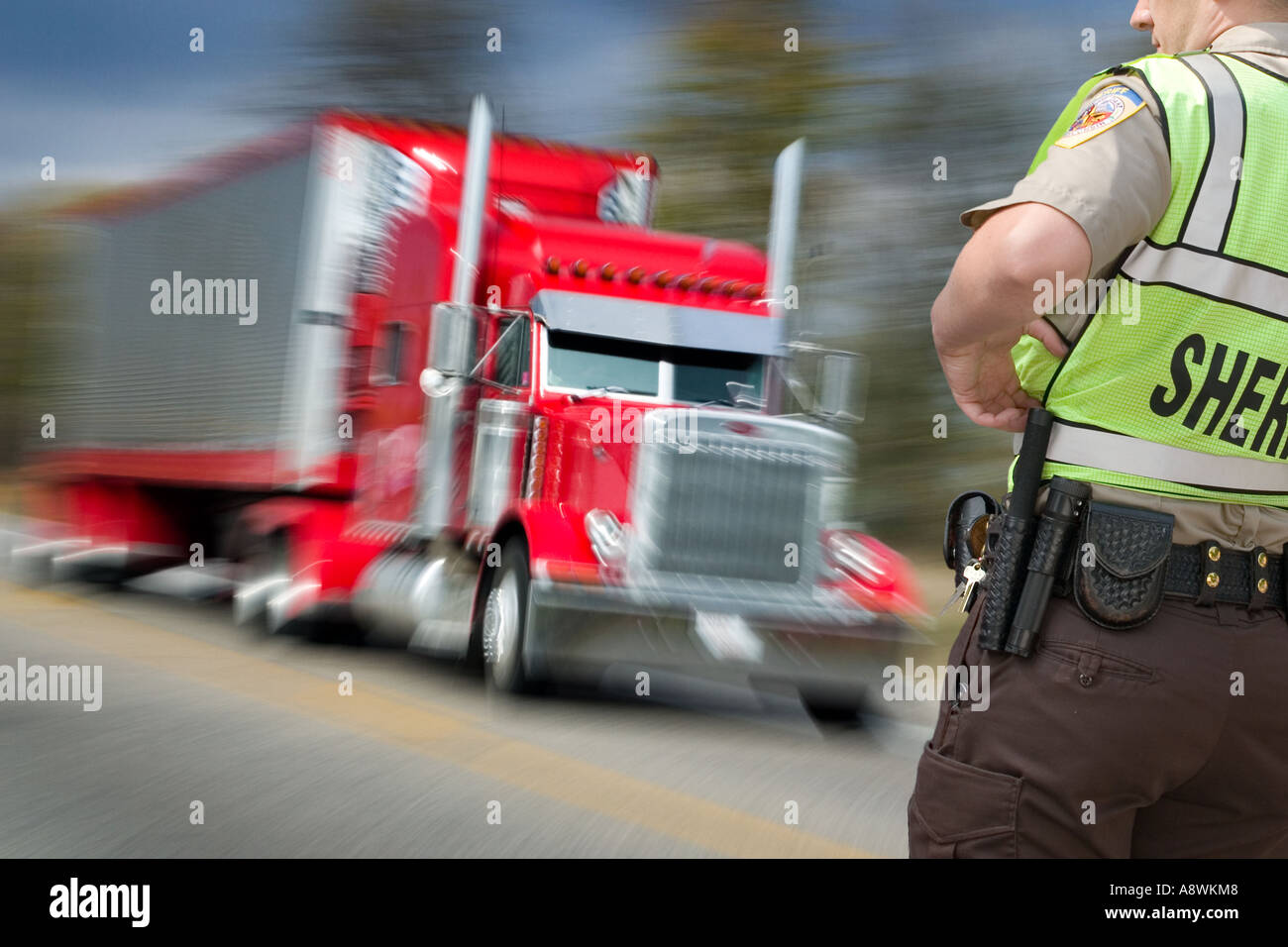 Transport truck speeding towards a police road block Stock Photo - Alamy