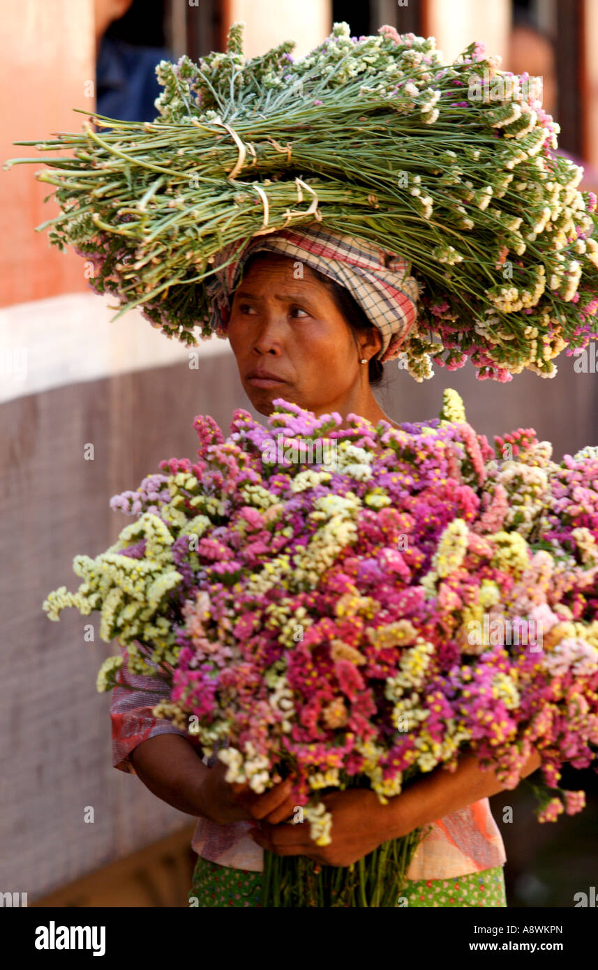 Asia, Myanmar, Burmese woman selling flowers at train stop Stock Photo ...