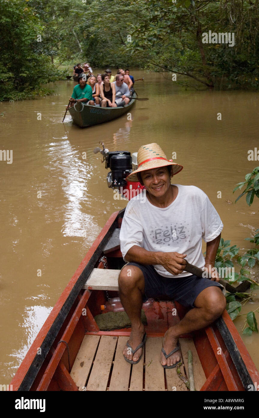 A group of tourists on a canoe trip on a tributary of the Amazon river ...