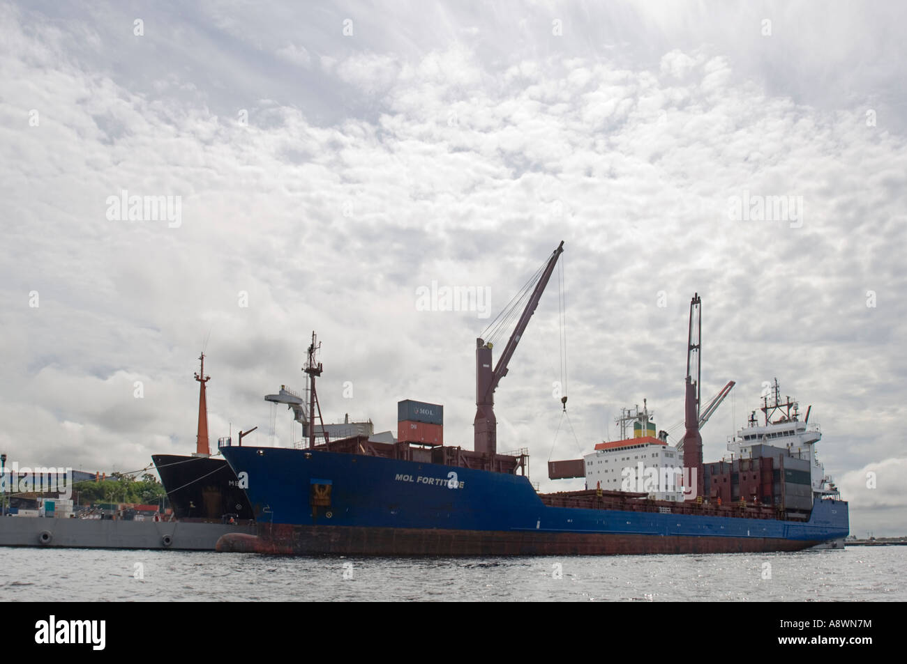 Container ships docked in the port of Manaus unloading or loading goods ...