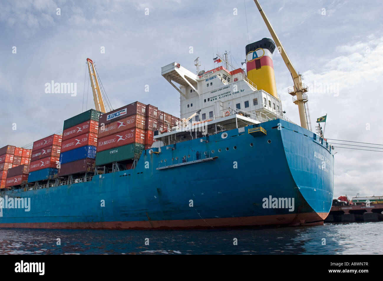 A Container ship docked in the port of Manaus unloading or loading ...