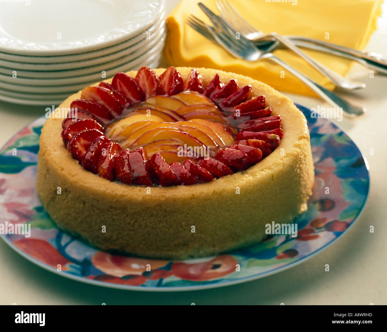 Strawberry and peach sponge flan, unsliced filled with glazed fruit ...