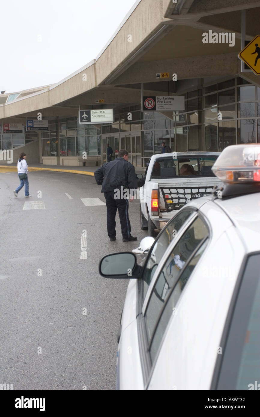 Police officer conducting a traffic stop outside the terminal building ...
