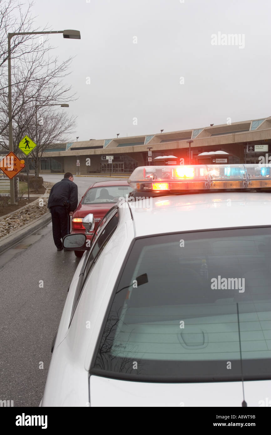 Police officer conducting a traffic stop outside the terminal building ...