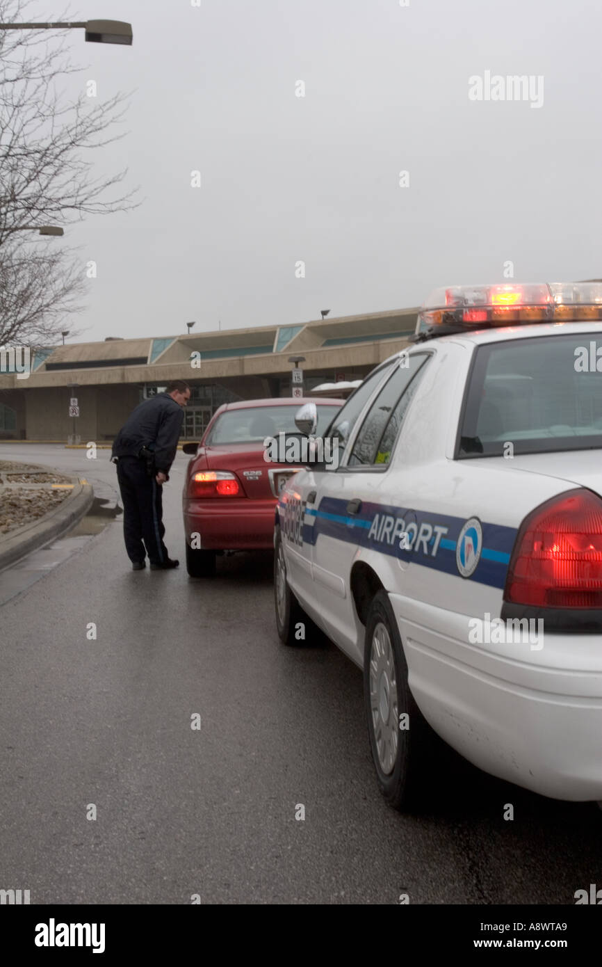 Police officer conducting a traffic stop outside the terminal building ...