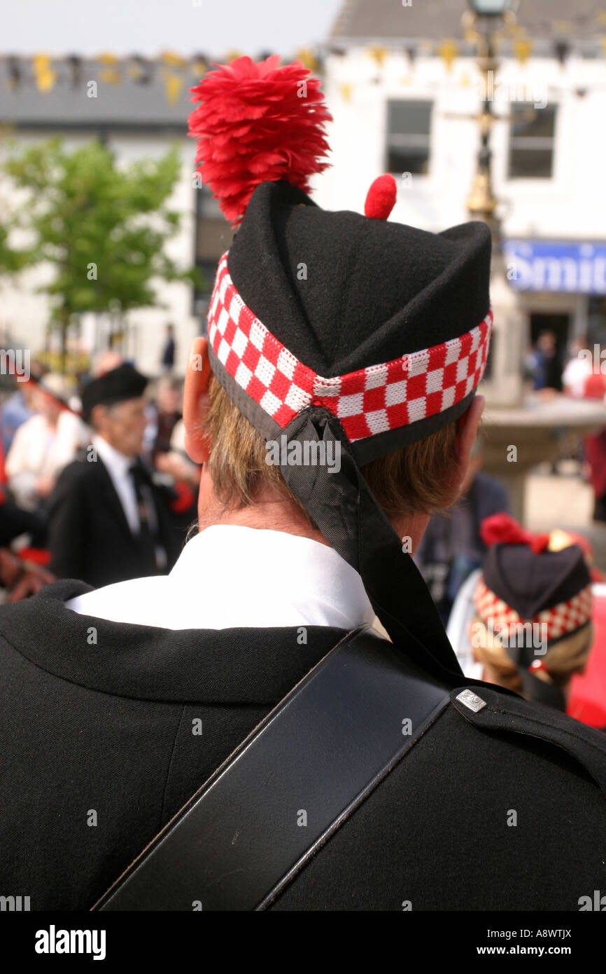 Member of Cornish pipe band wearing tartan hat with red feather Stock ...