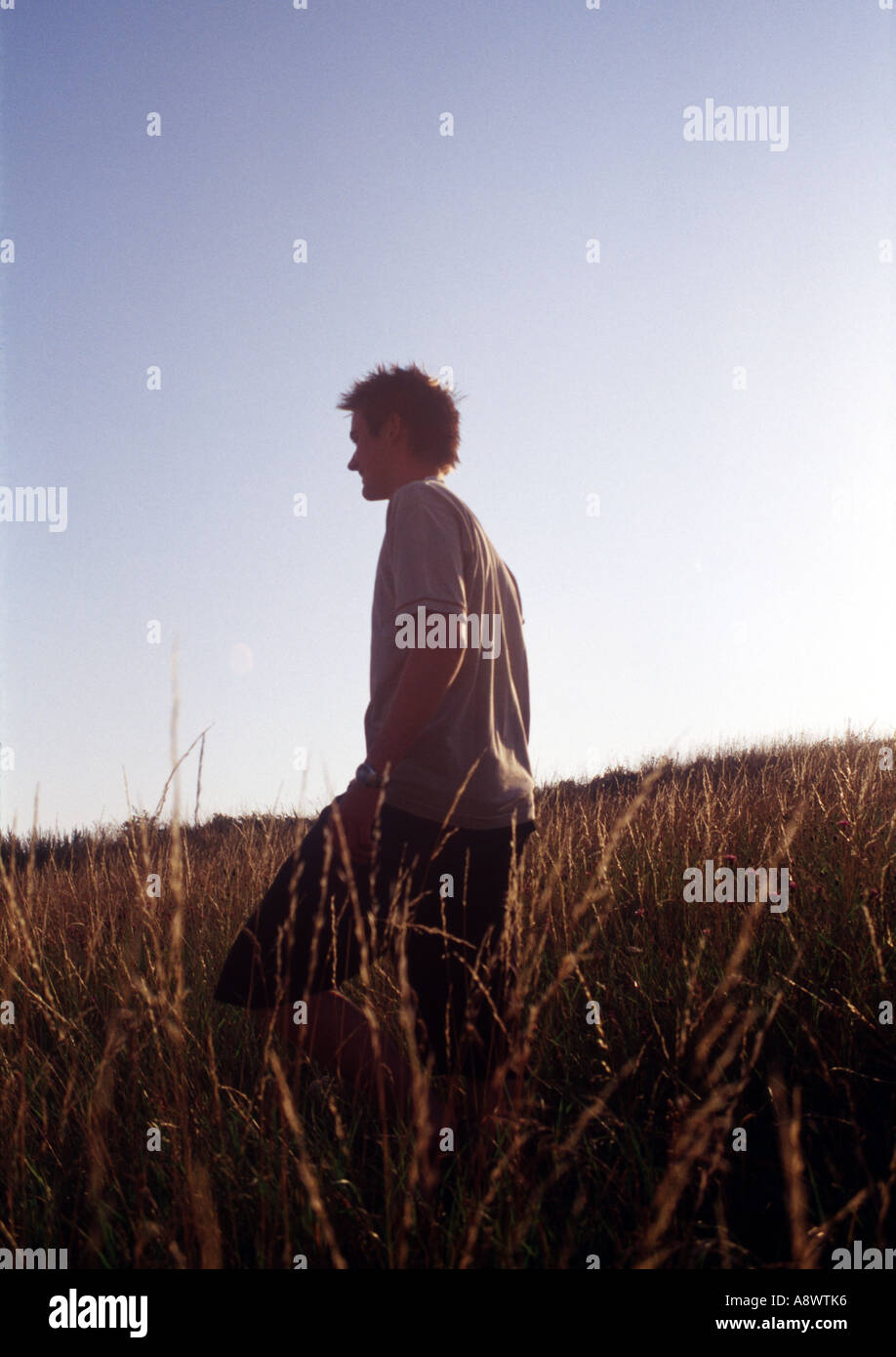 Rear view of a man walking through a field hi-res stock photography and ...