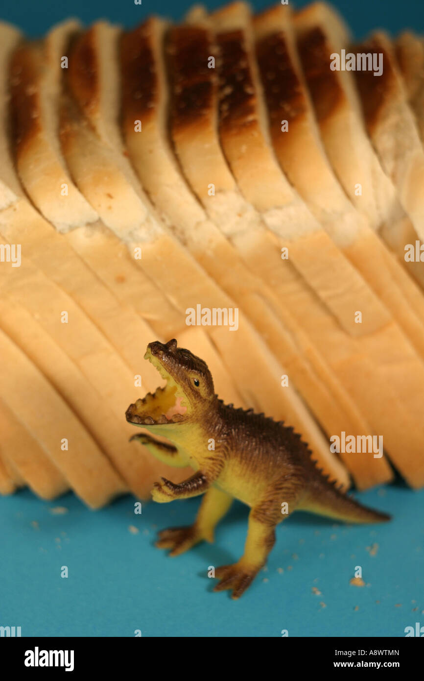 Sliced white bread with plastic dinosaur Stock Photo - Alamy