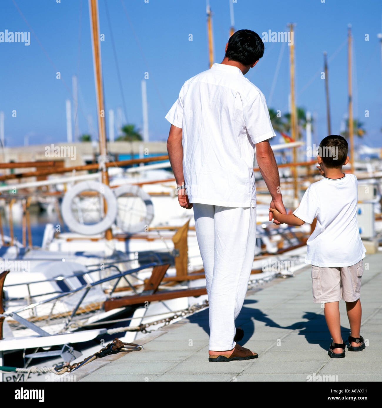 FATHER AND SON WALKING ON JETTY Stock Photo - Alamy