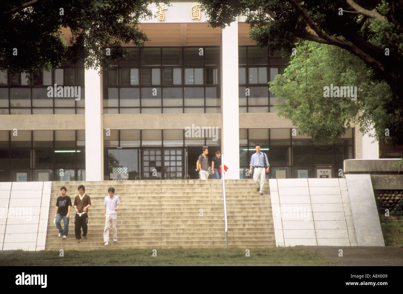 Chinese Asian university students walking on college campus outside the ...
