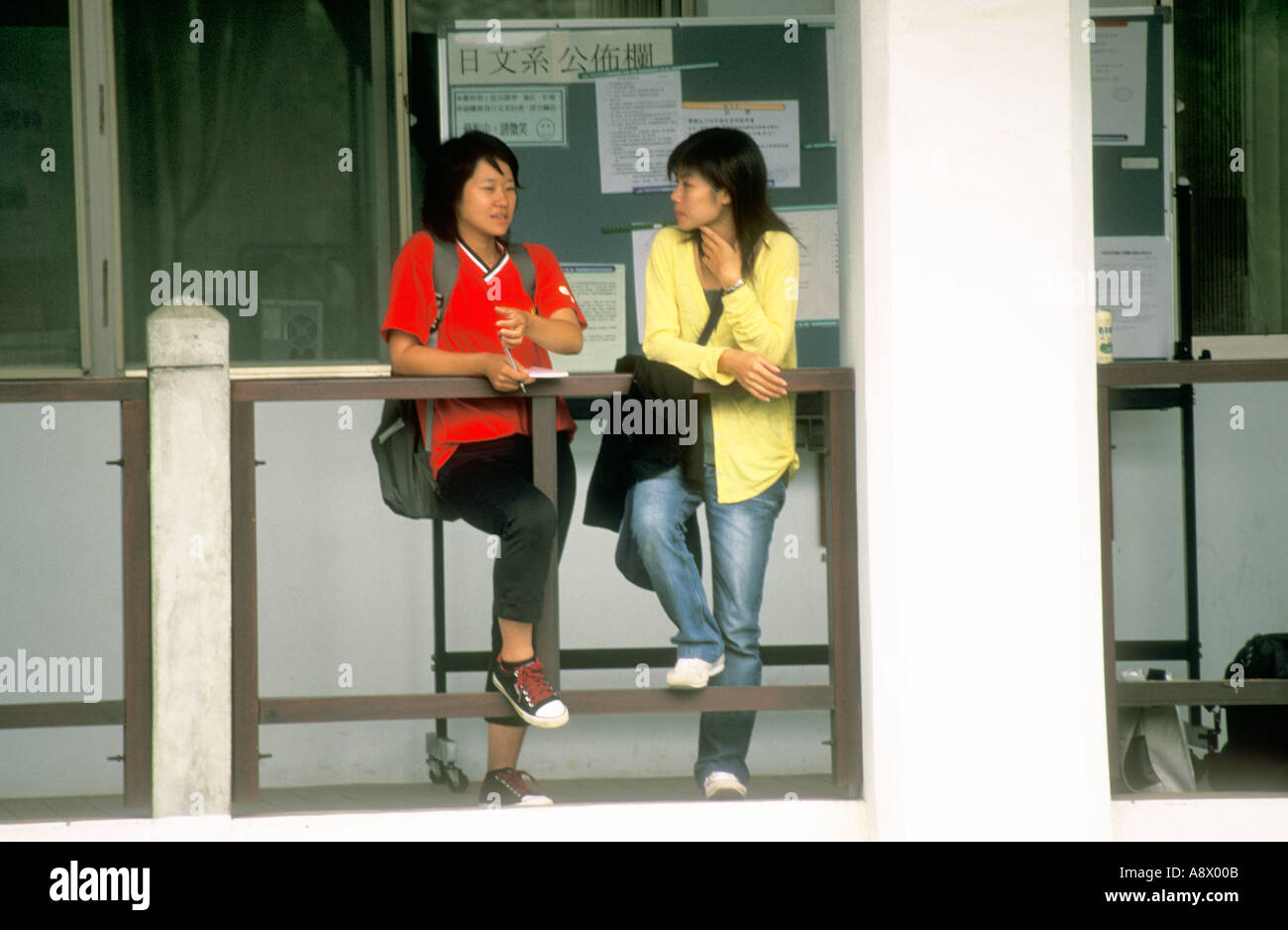 Chinese Asian university students talking outside of classroom on ...