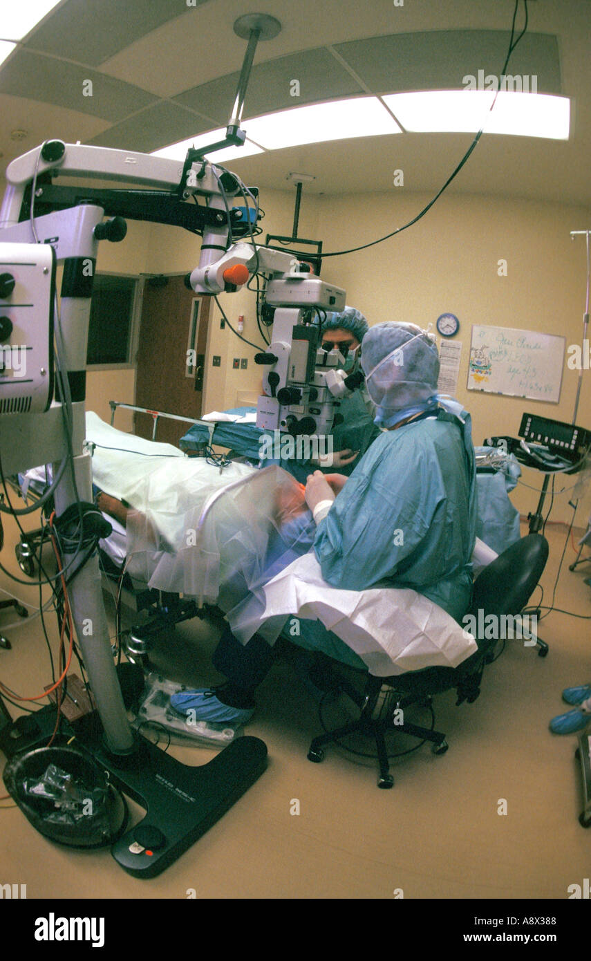 ophthalmologist uses electronic overhead operating microscope to ...