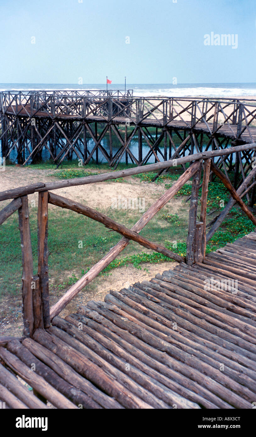 Wooden bridge from a tourist resort leading to sandy beach Varca beach ...