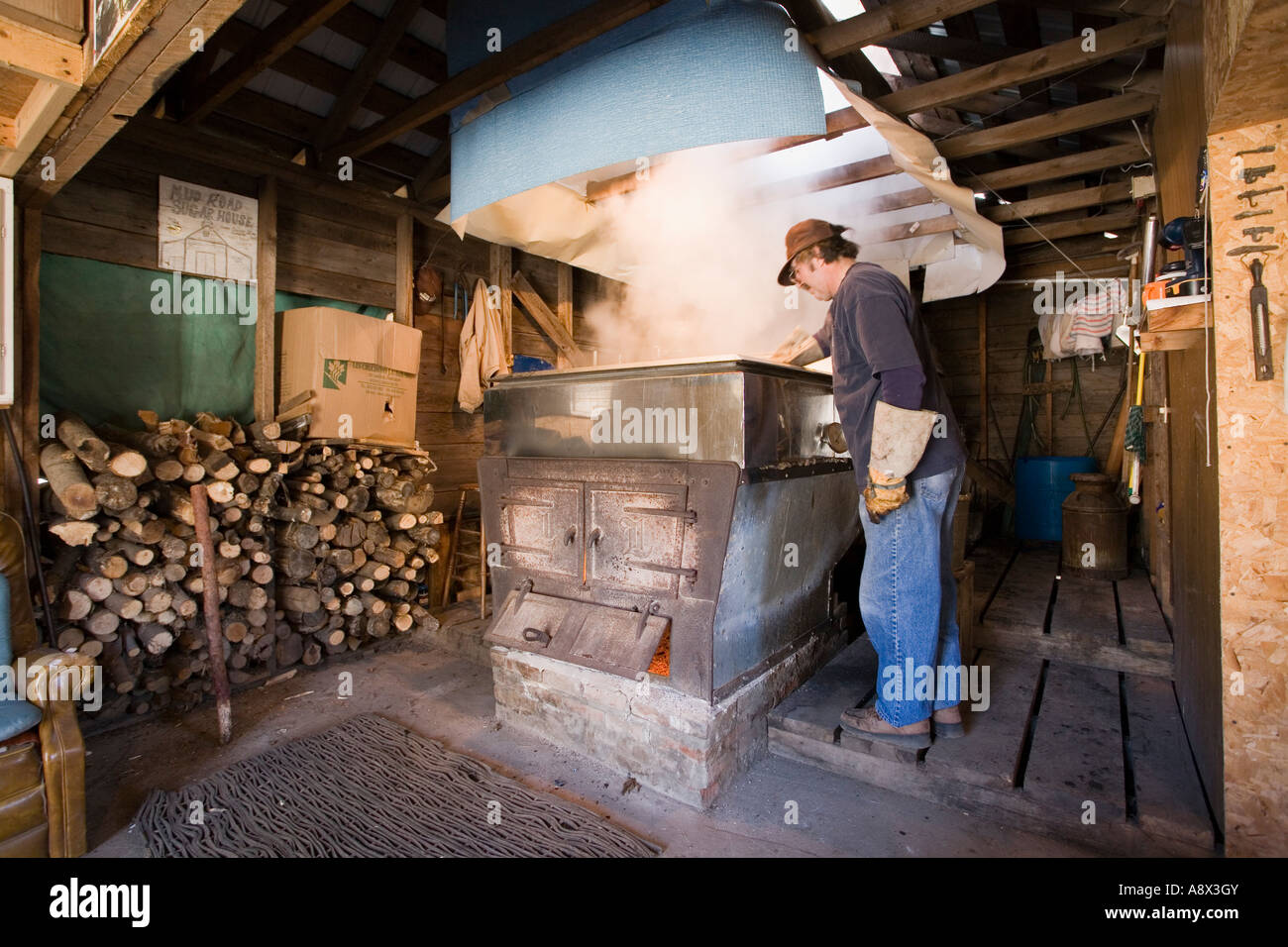 Boiling tree sap in evaporator making maple syrup upstate New York ...