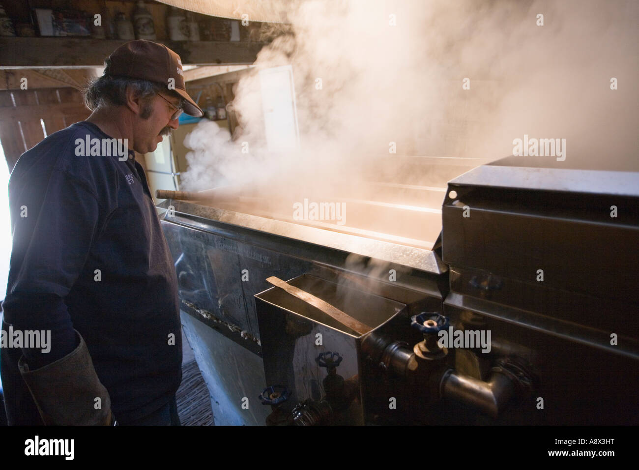 Boiling tree sap in evaporator making maple syrup upstate New York ...