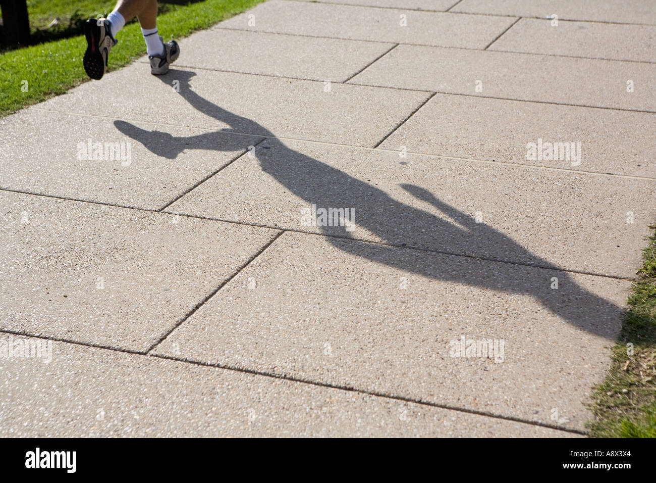Shadow of Runner Stock Photo - Alamy