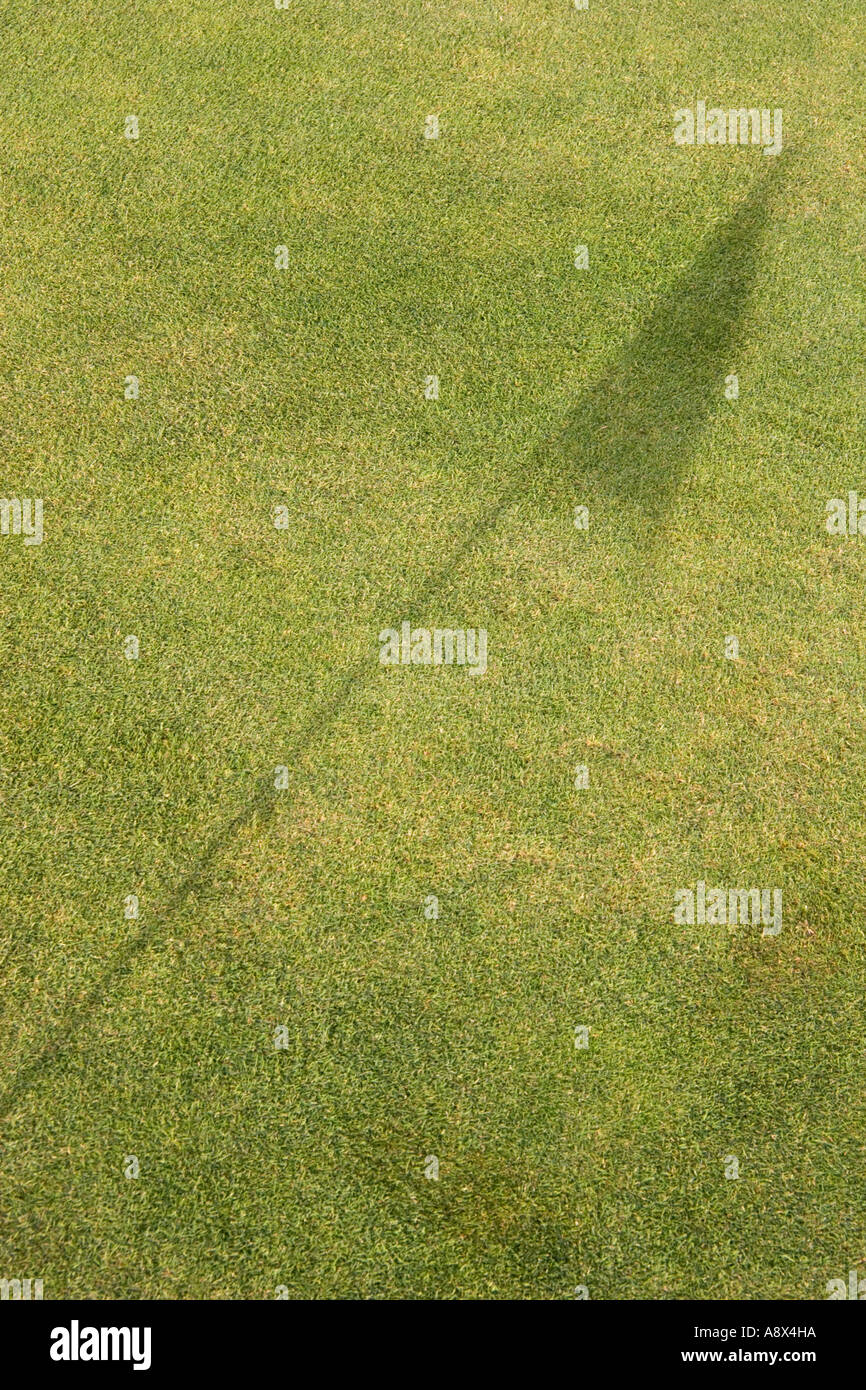 Shadow of flag on green at golf course Stock Photo - Alamy