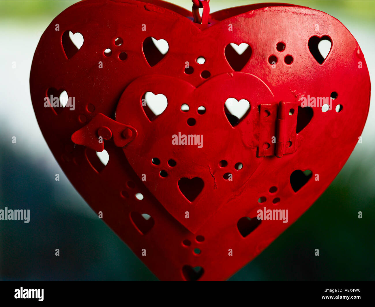 red metal heart with little hearts cut into it Stock Photo - Alamy