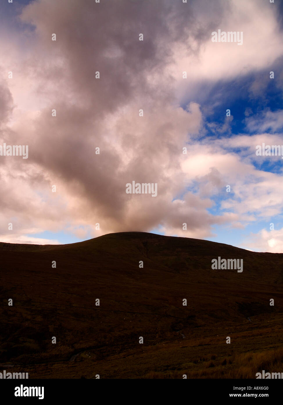 Cloud spews forth volcano like from the top of a mountain in the ...
