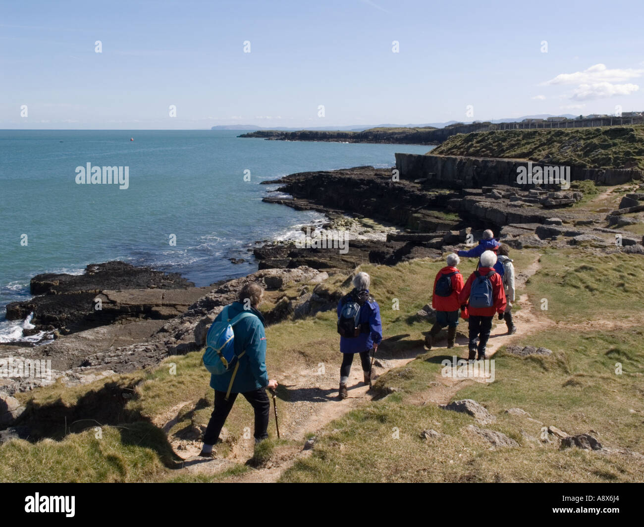 Group of adult walkers walking on Isle of Anglesey Coastal Path from ...