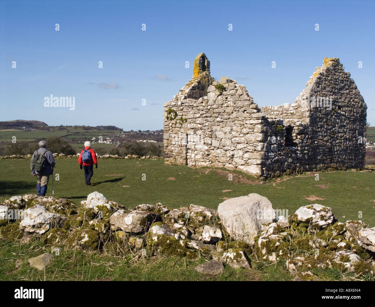 CAPEL LLIGWY with walkers visiting remains of small 12th century chapel ...